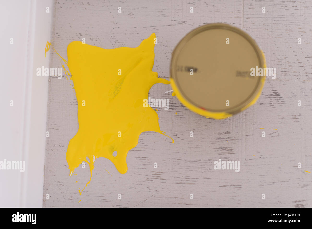 Yellow paint tin can with yellow strokes on the wooden floor Stock ...