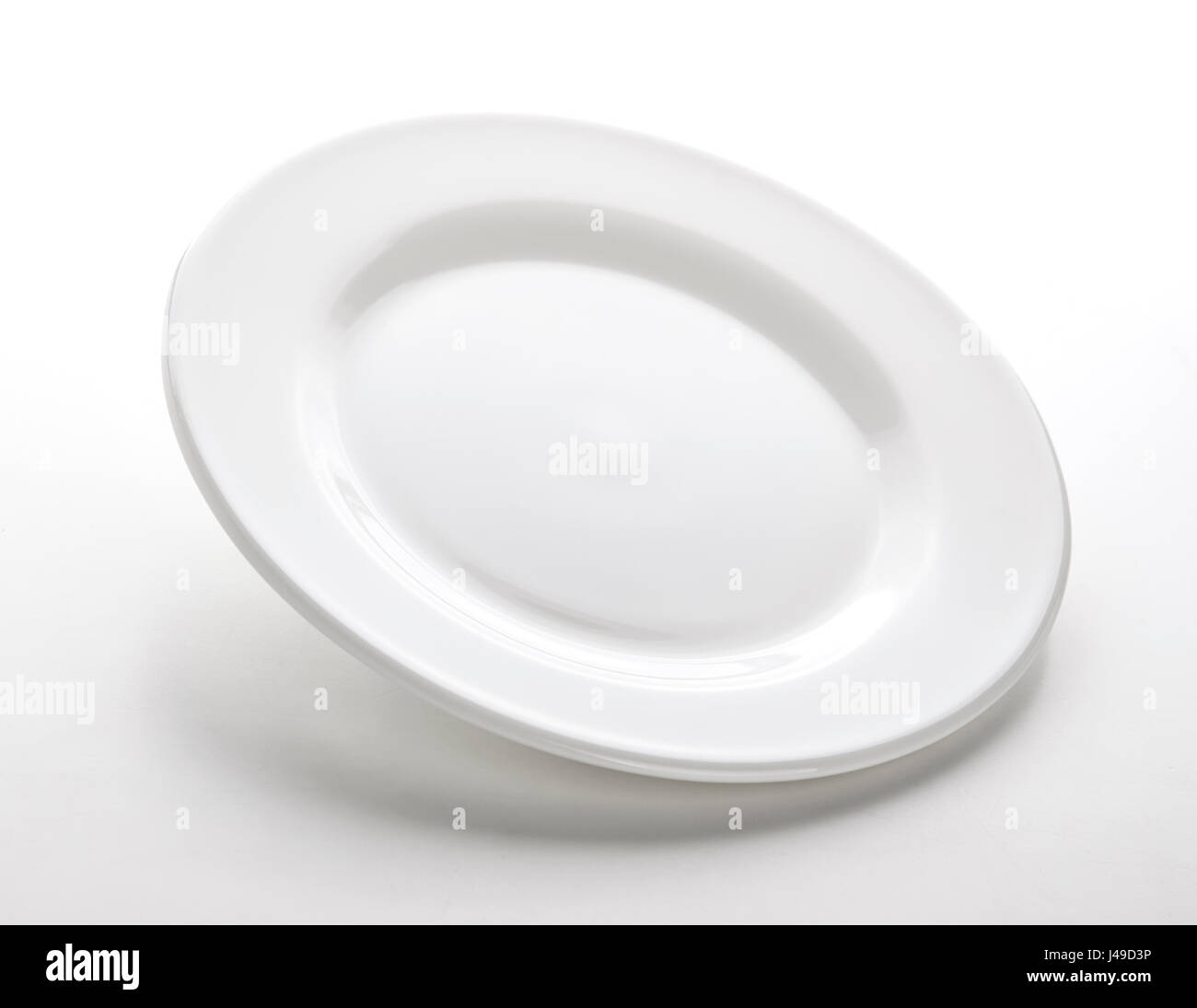 White plate isolated on white table, empty dish template Stock Photo ...