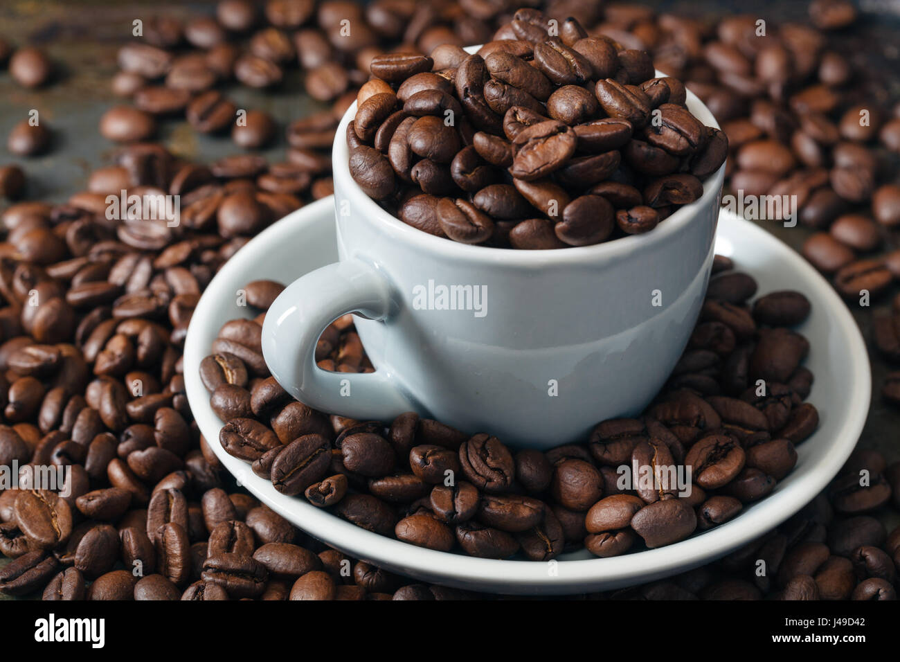 Coffee beans in coffee cup Stock Photo - Alamy