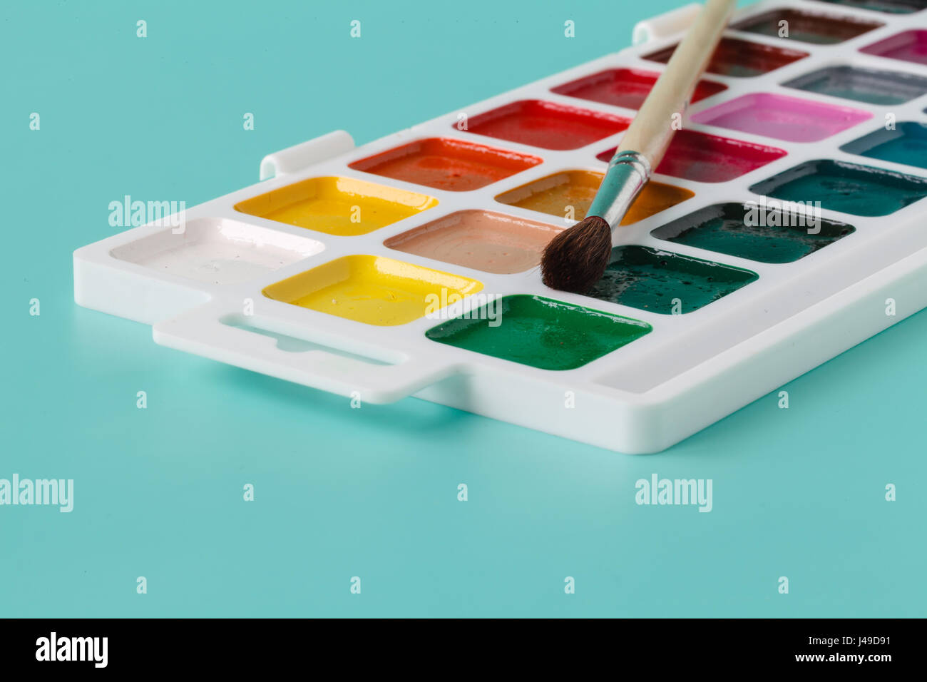 Watercolor paint and brush in white box, on blue background Stock Photo ...