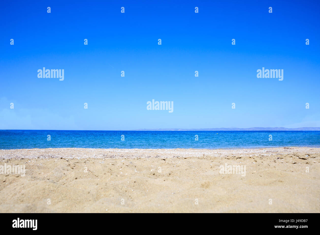 Sandy beach on blue sky and sea background Stock Photo - Alamy