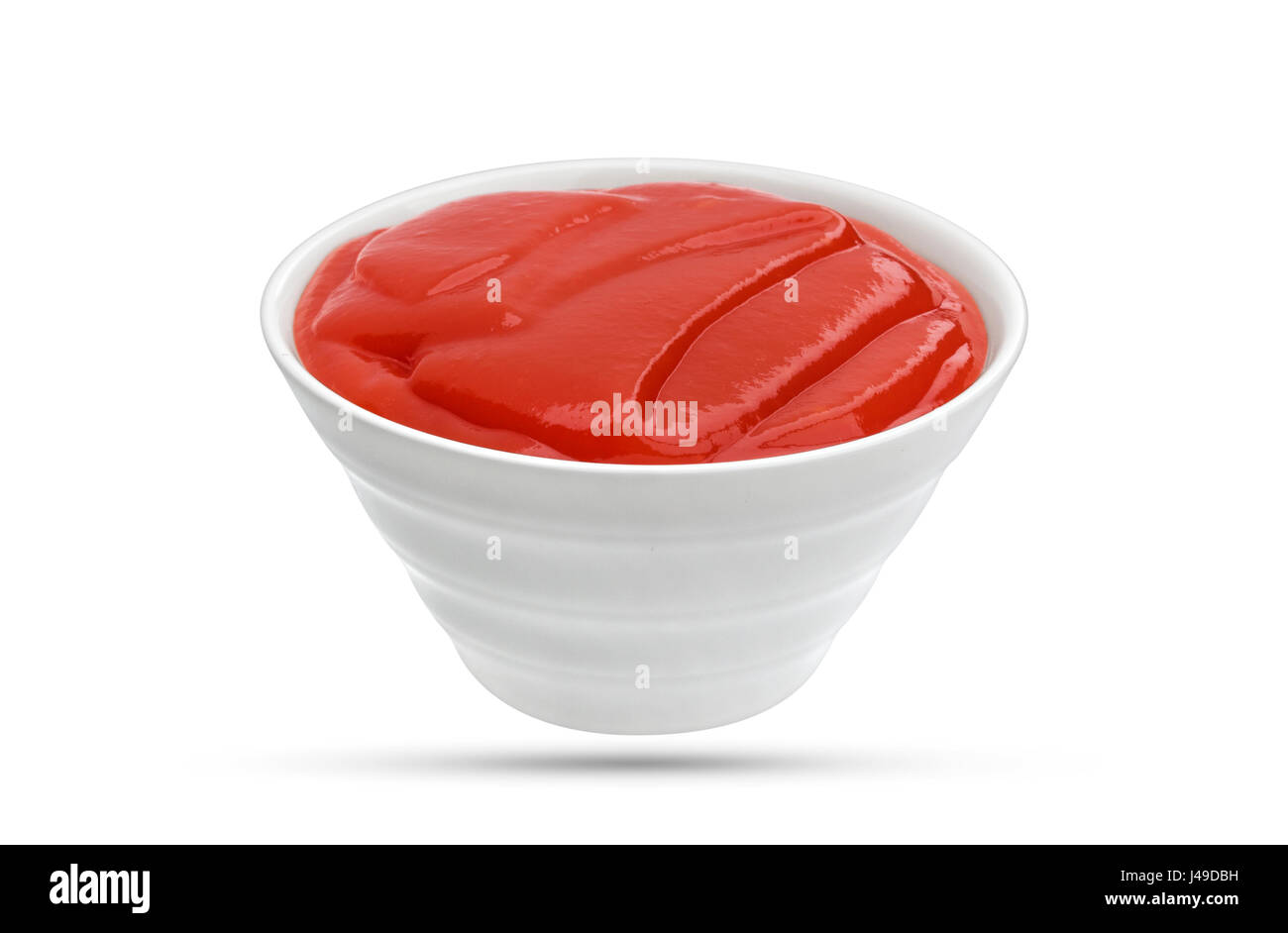 Ketchup in bowl isolated on white background. Portion of red tomato ...