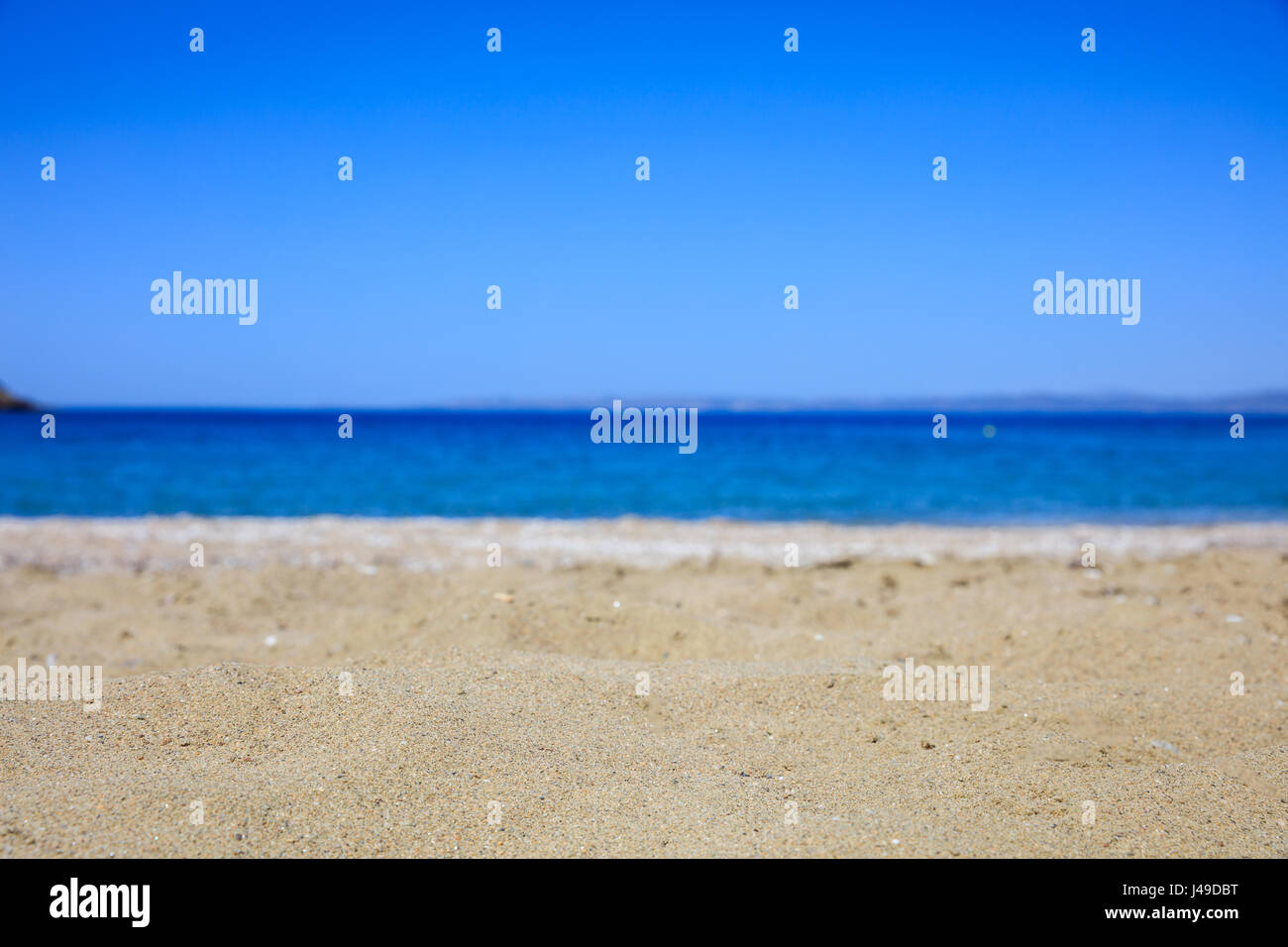 Sandy beach on blue sky and sea background Stock Photo - Alamy