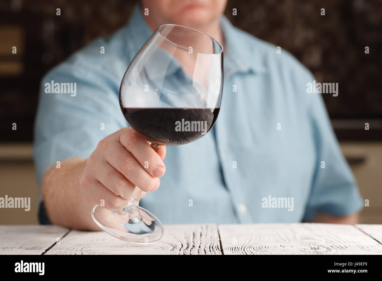 Man Drinking Red Wine on kitchen Stock Photo - Alamy