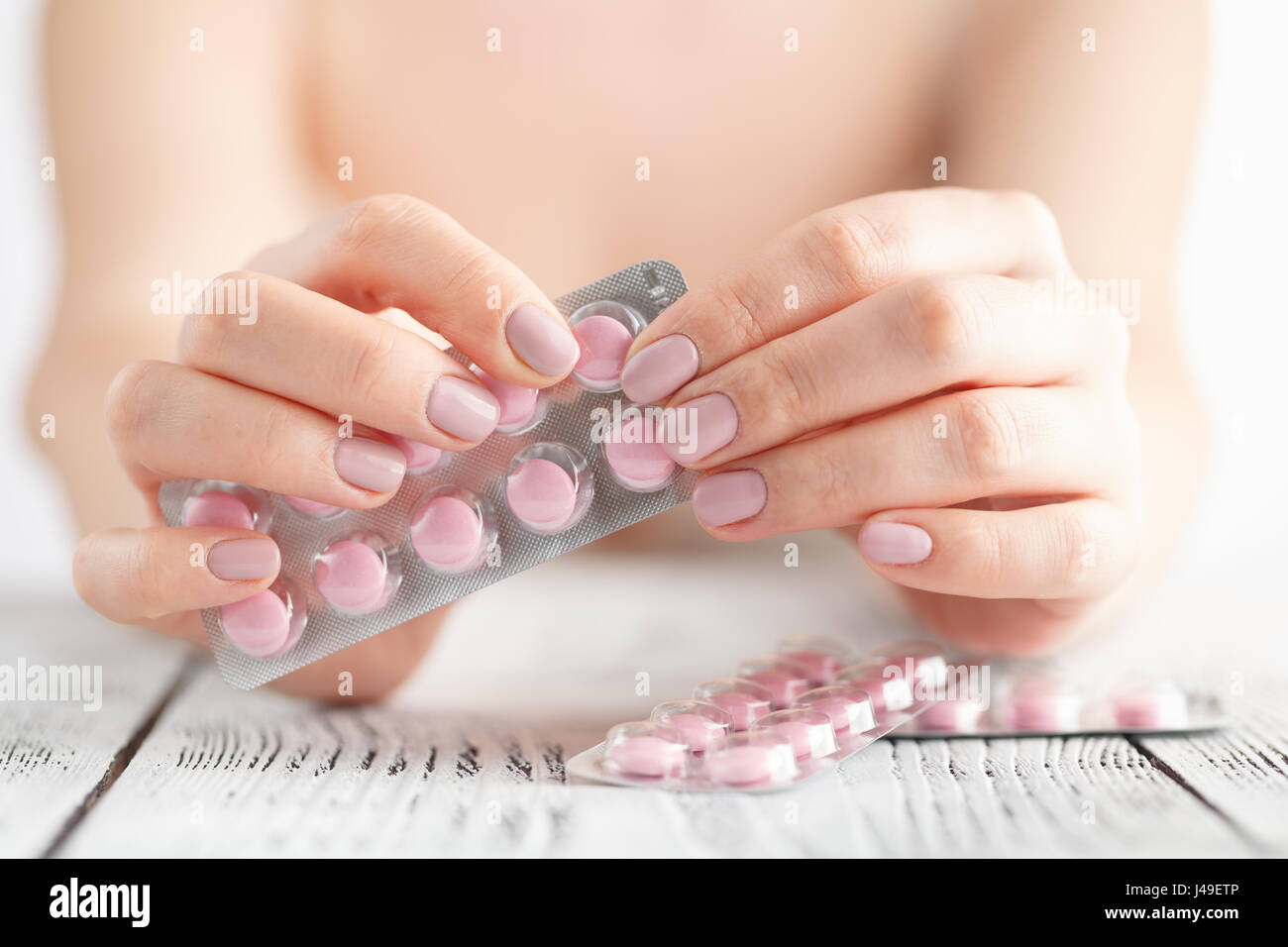 female Hand holding a pink pill.Closeup view Stock Photo - Alamy