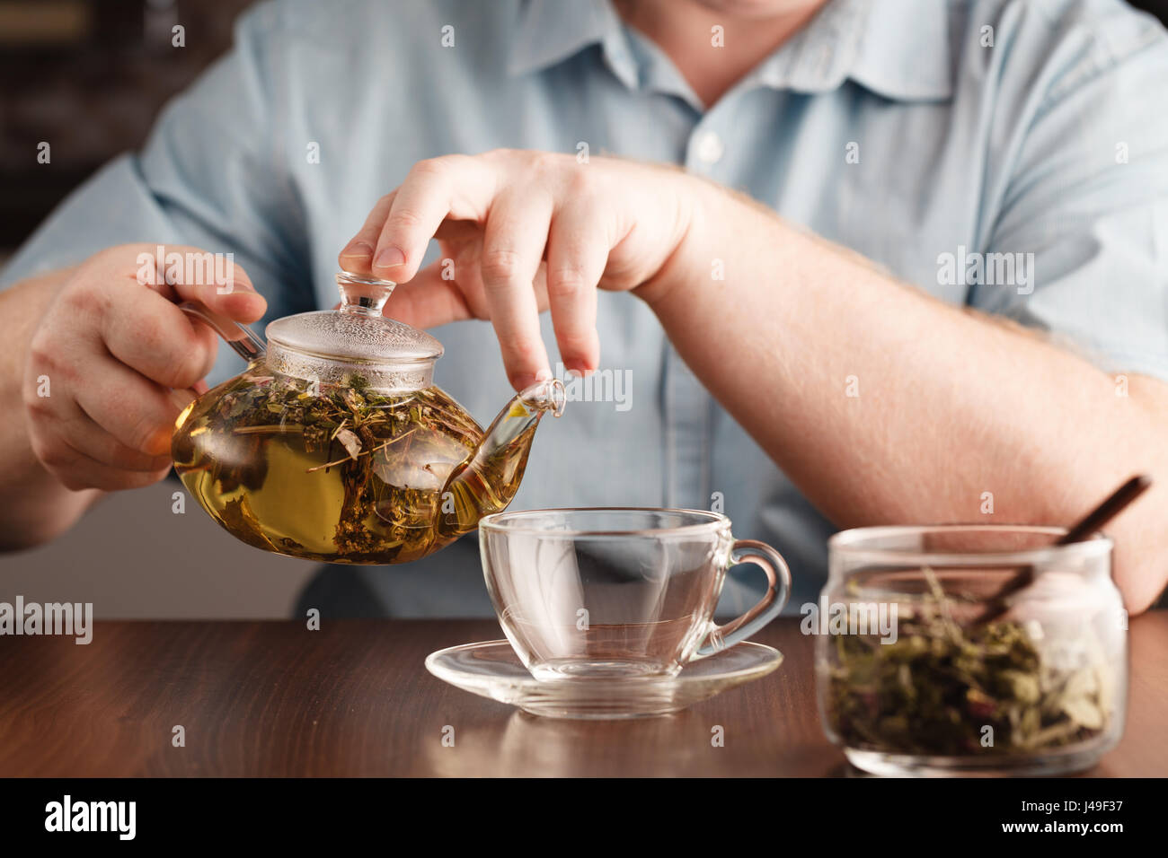pour hot herblal tea into cups Stock Photo - Alamy