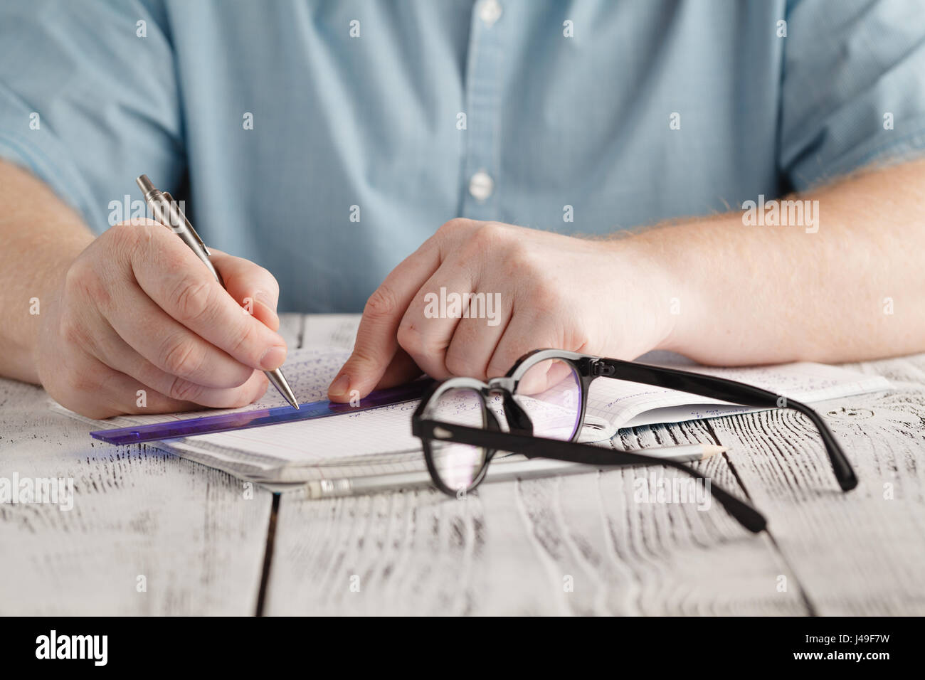 Close up male's hand writing on paper, writing messy math,student hold ...