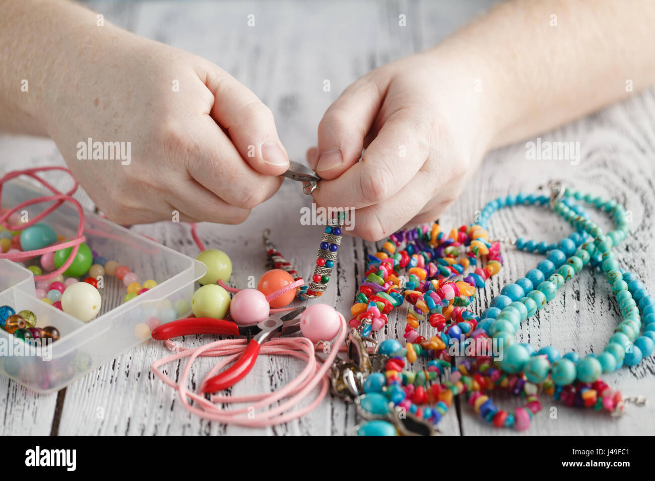 Man repairing or creating jewelry silver chain with pliers Stock Photo ...