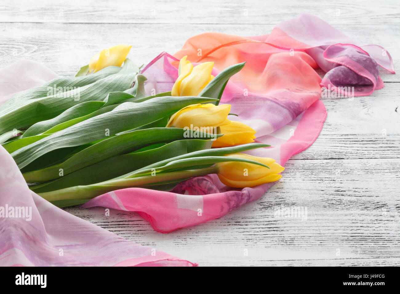 Pile of yellow tulips lay on table Stock Photo - Alamy