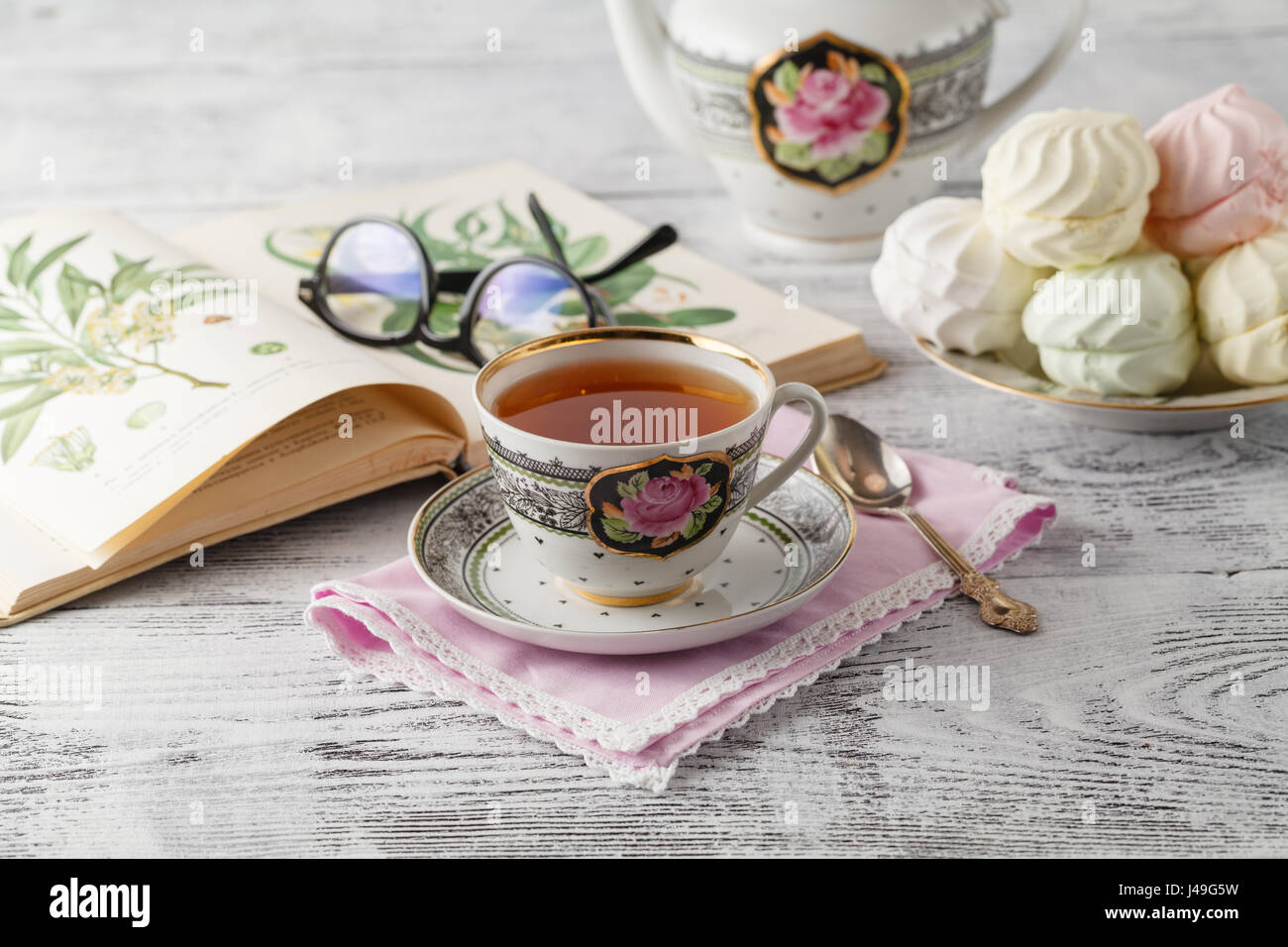 Cup of tea, book on wooden table Stock Photo - Alamy