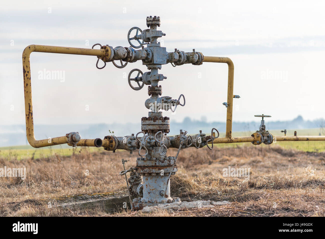 Old gas pipeline in the middle of the field. Extraction of gas from ...