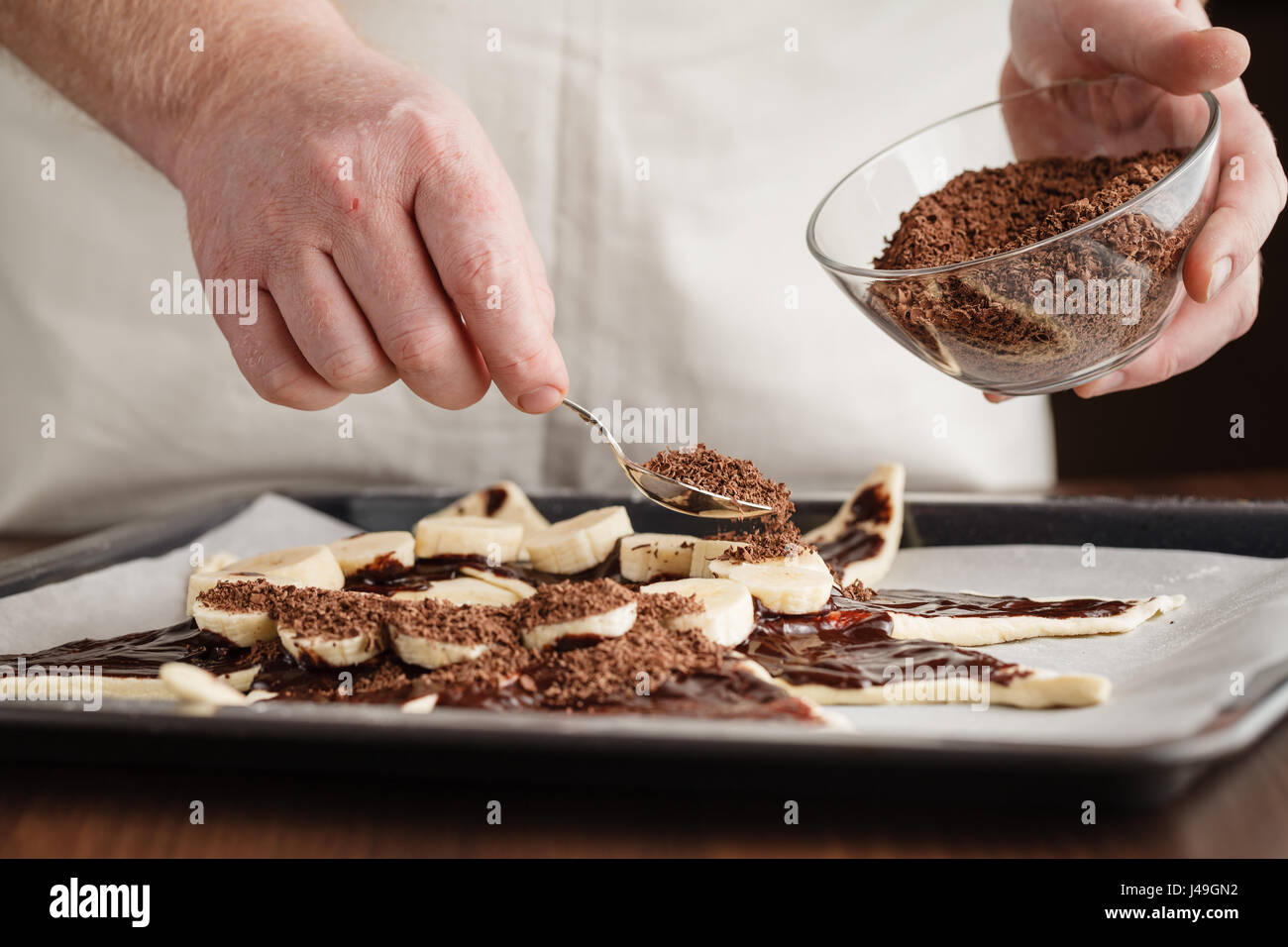 Chef pouring cake batter in a baking tin, close up Stock Photo - Alamy