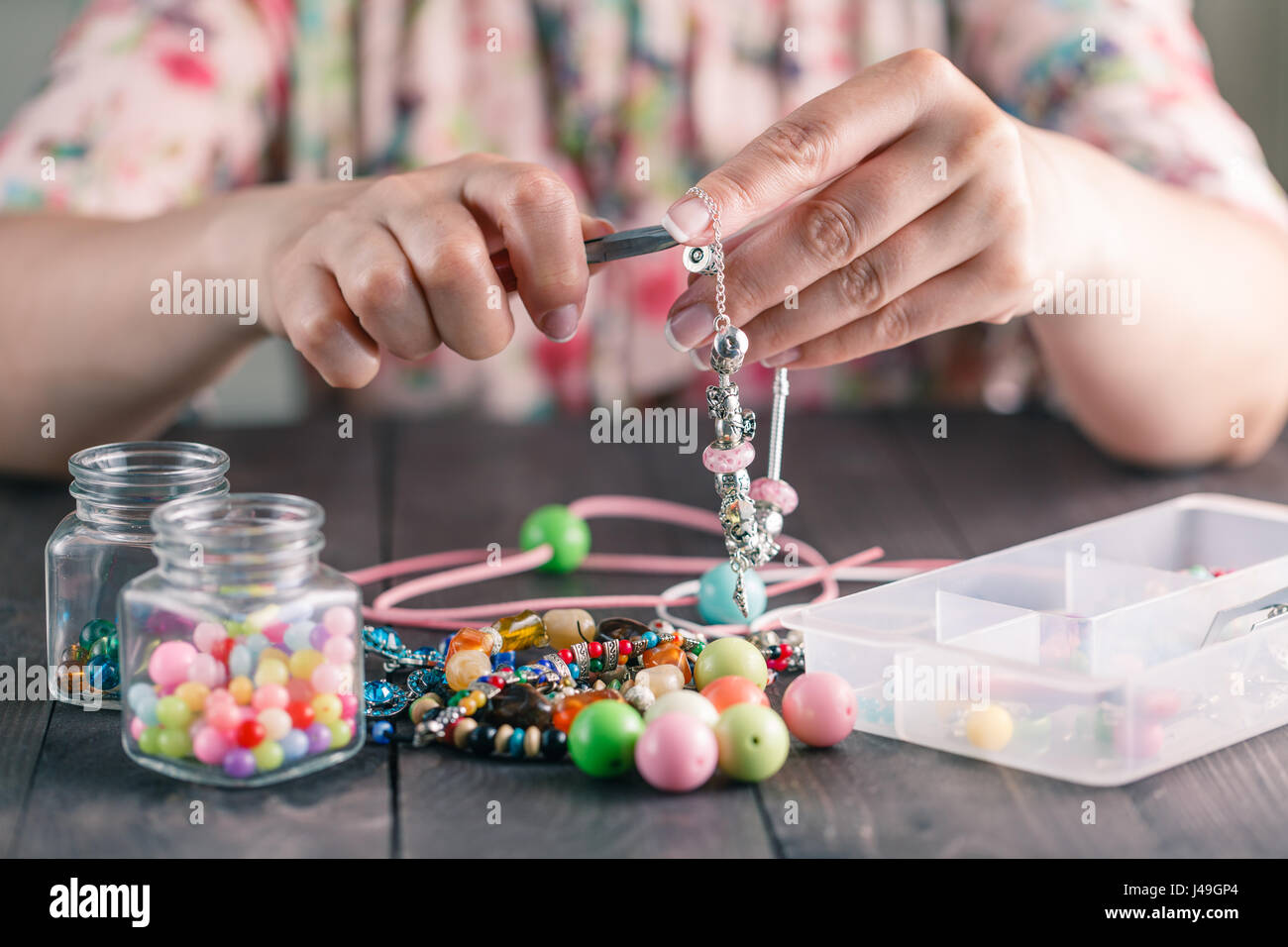 Making of handmade jewellery. Woman make homemade bracelet Stock Photo ...