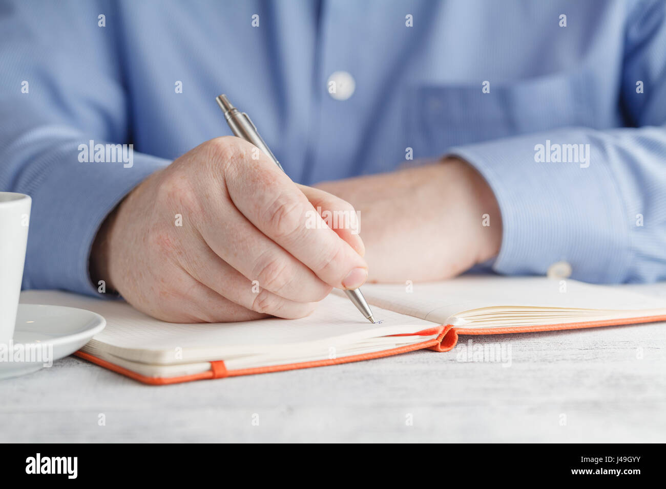 male hand writing in notebook with pen Stock Photo - Alamy
