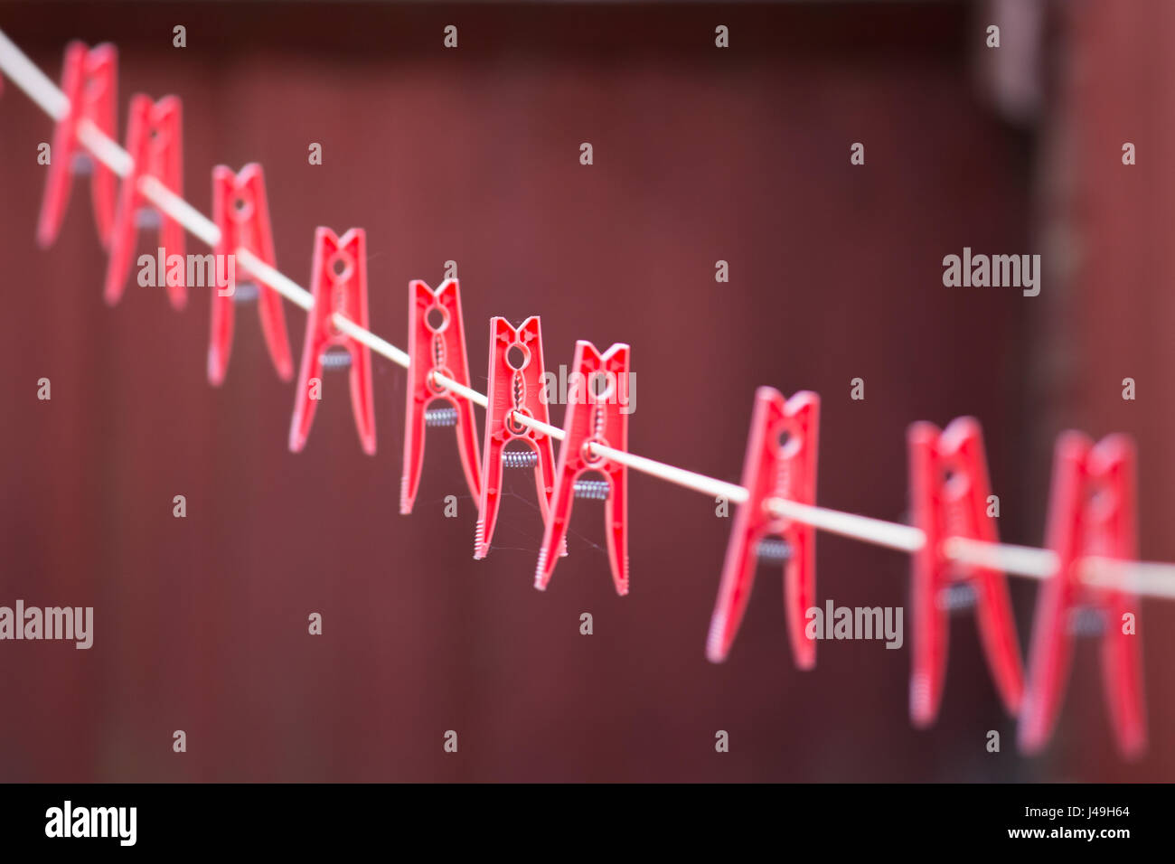 Red Pegs On A Washing Line with a shallow depth of field Stock Photo ...