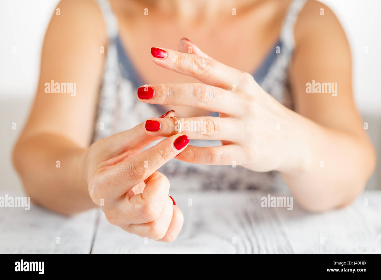 Woman taking off wedding ring hi-res stock photography and images - Alamy