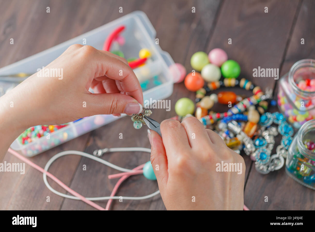 Woman hands making beads, closeup view Stock Photo - Alamy