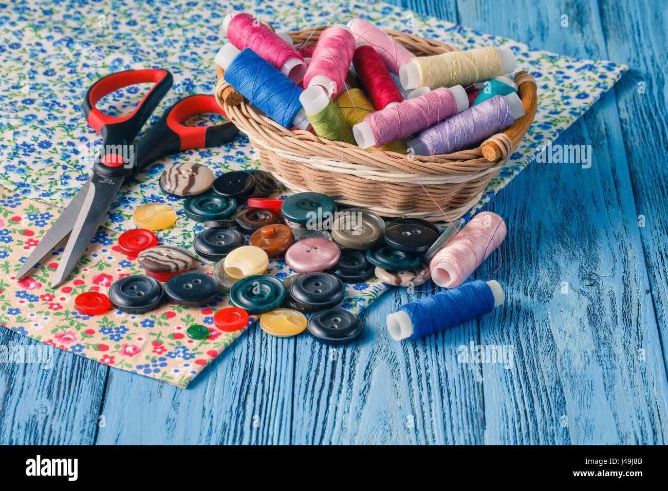 String and buttons on blue wooden table Stock Photo - Alamy