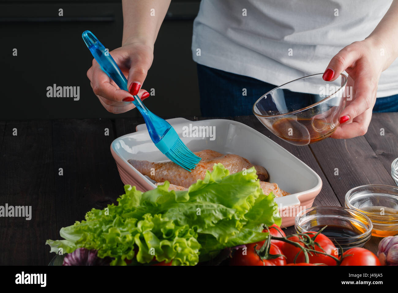 Woman hands frying chicken legs Stock Photo - Alamy