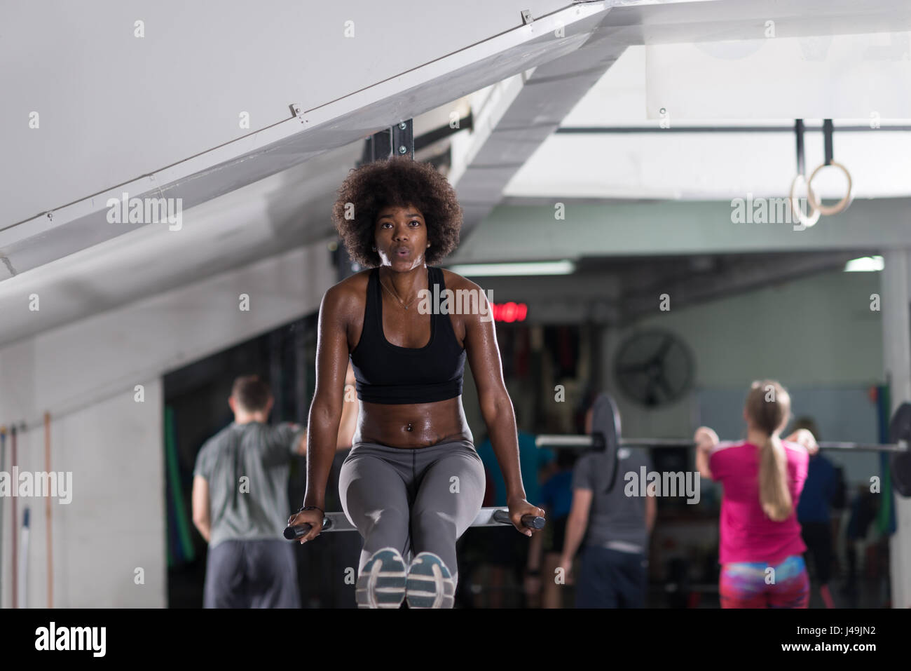 african american athlete woman workout out arms on dips horizontal ...