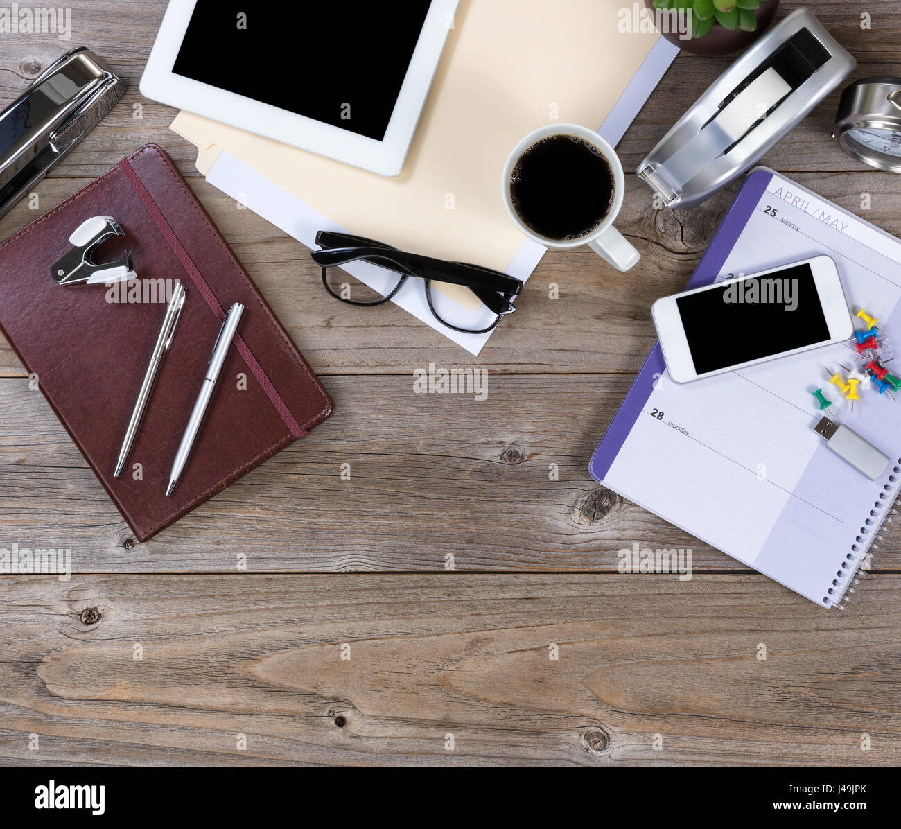 Flat lay view of working desktop on rustic wood setting Stock Photo - Alamy