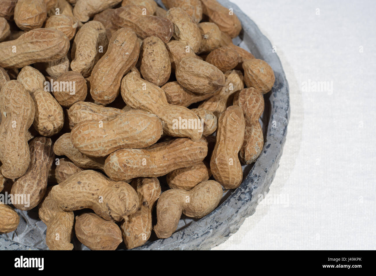 Peanuts in shell on the grey pate, white backgound, copy space Stock ...