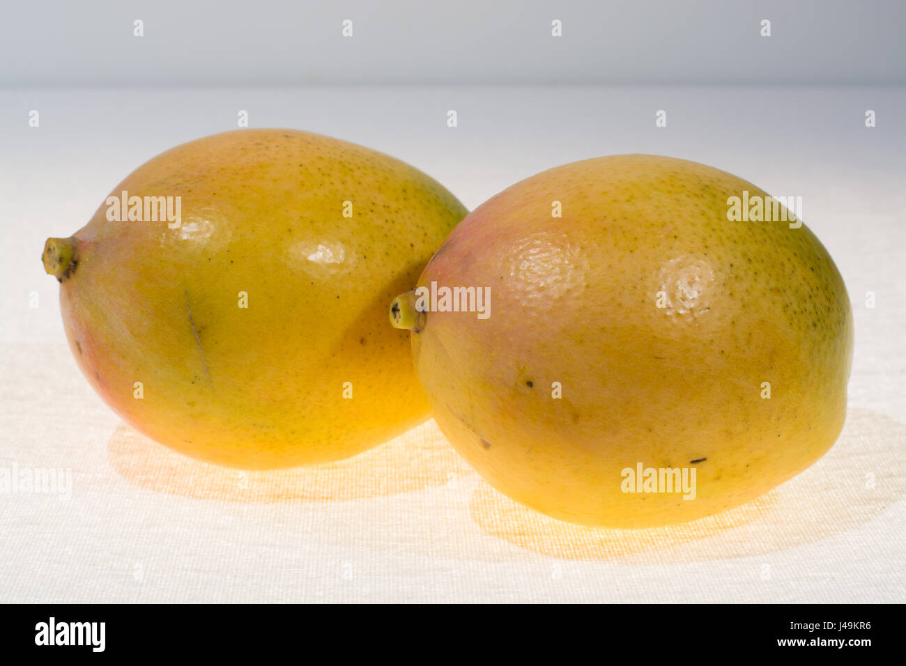 Two ripe organic golden yellow mangoes ready to eat close up Stock ...