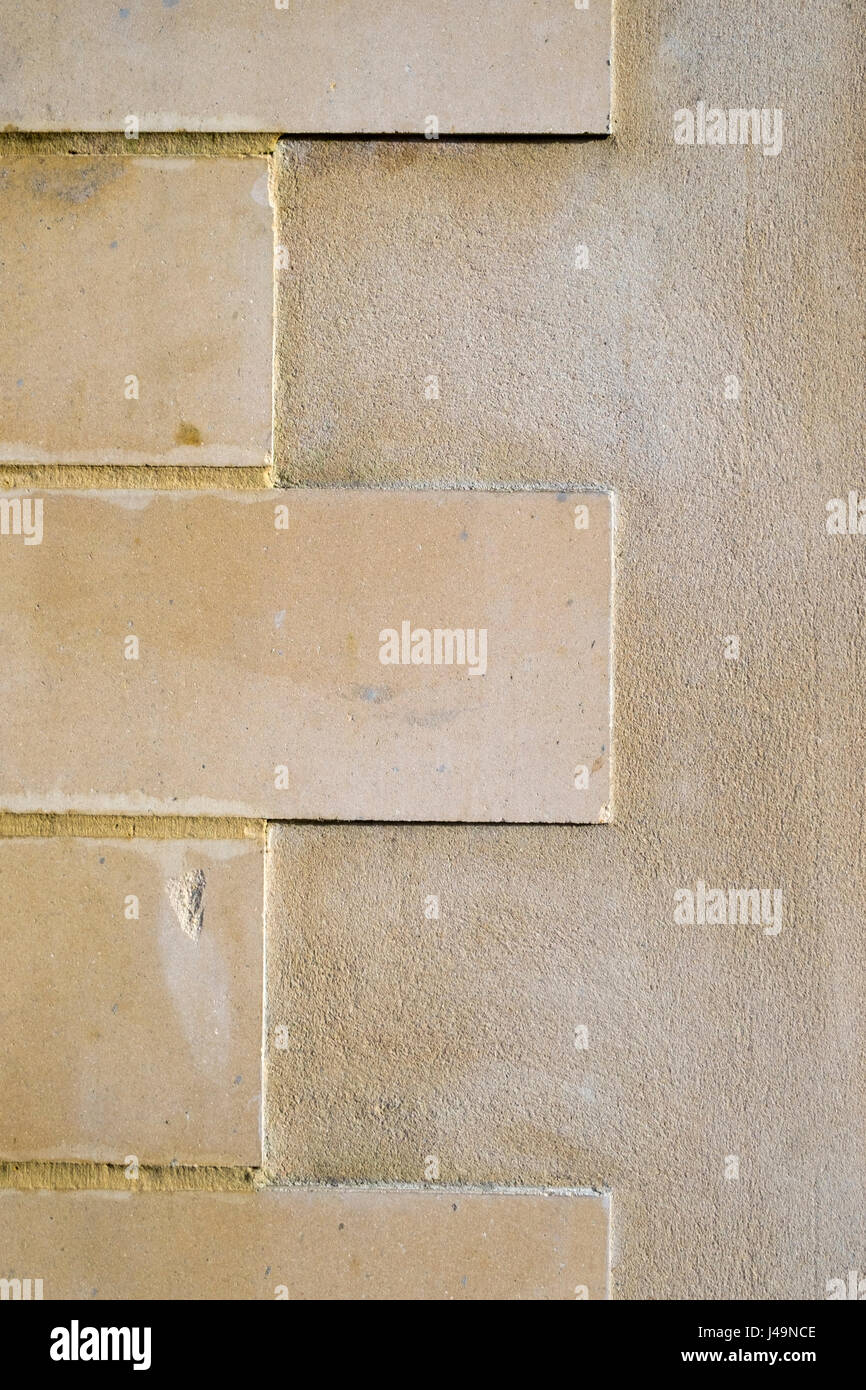 Dressed stone and render exterior wall detail full frame background ...