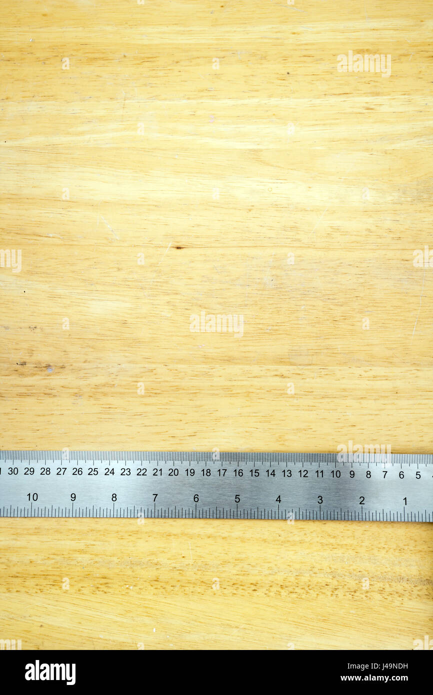A shiny new steel rule on wood with copy space Stock Photo - Alamy