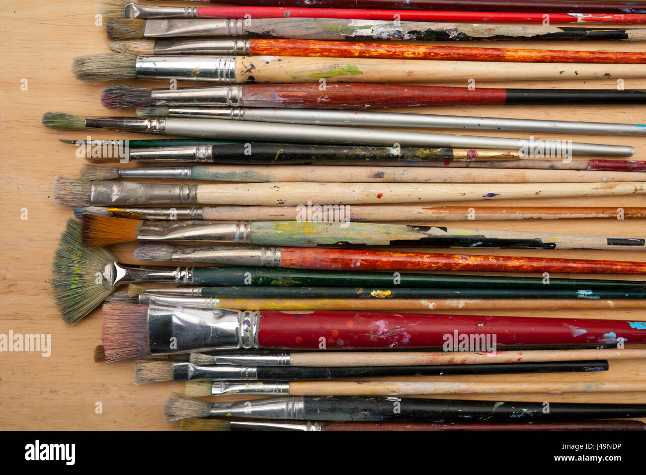 A collection of well used art paint brushes on wood Stock Photo - Alamy