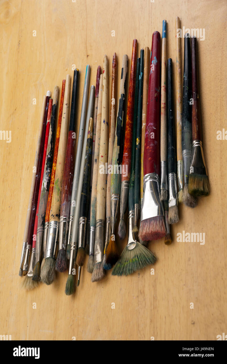 A collection of well used art paint brushes on wood Stock Photo - Alamy