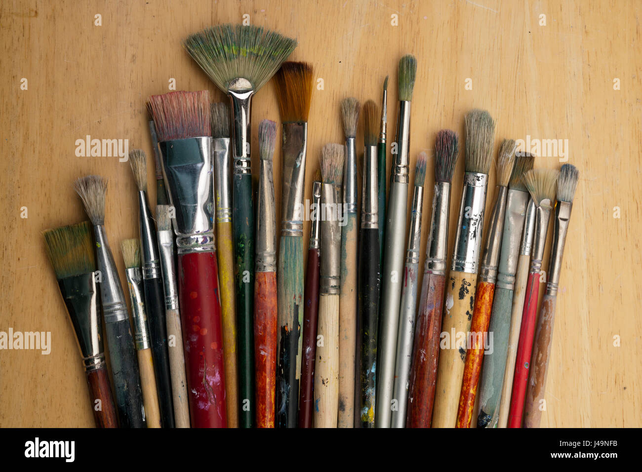 A collection of well used art paint brushes on wood Stock Photo - Alamy