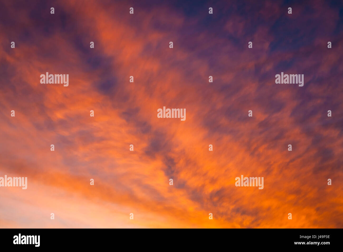 Fiery vivid sunset sky clouds Stock Photo - Alamy