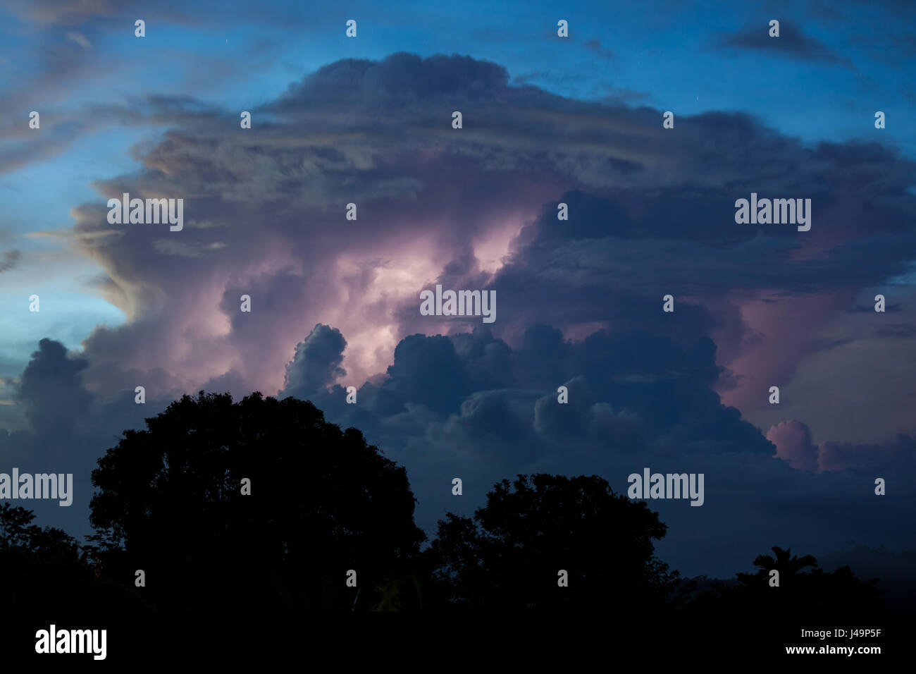 Thundercloud illuminated by lightning Stock Photo - Alamy