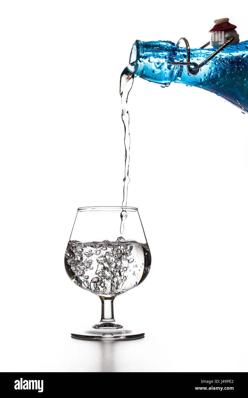 water drop by a blue bottle in a cocktail clear glass Stock Photo - Alamy