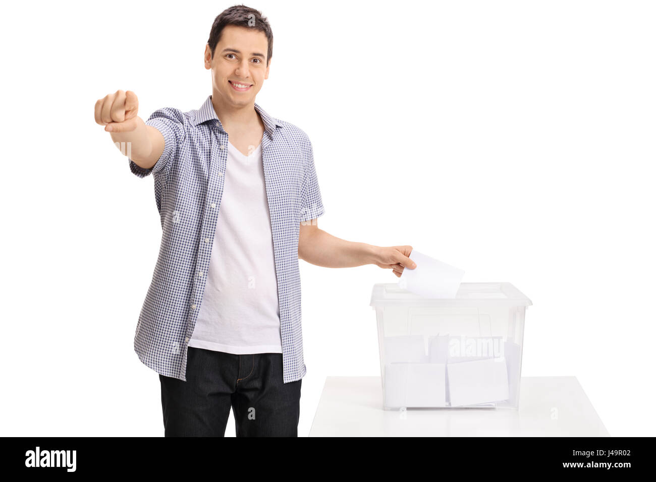 Voter casting a vote into a ballot box and pointing at the camera ...