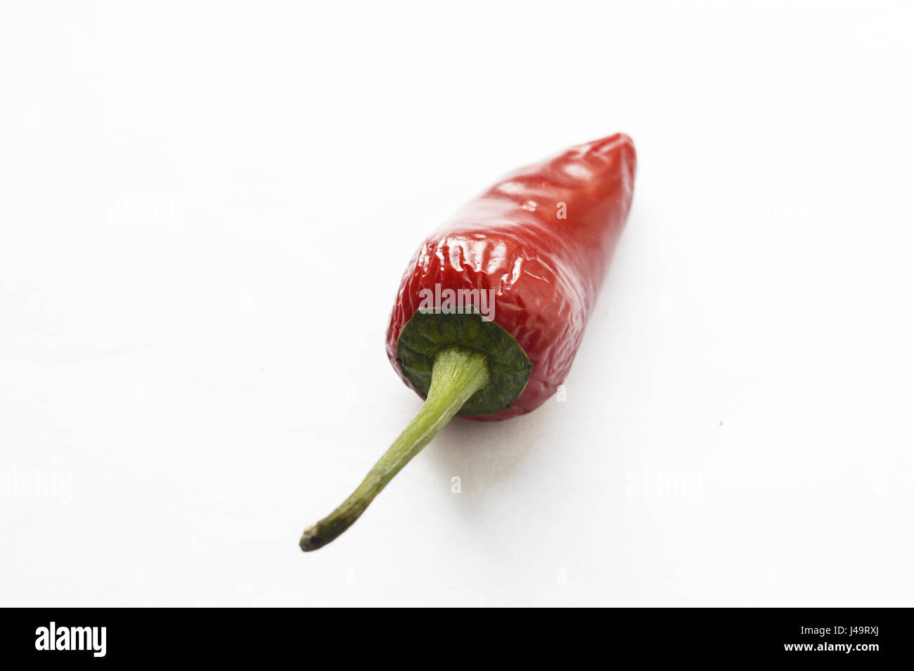 small red chili pepper isolated on white Stock Photo - Alamy