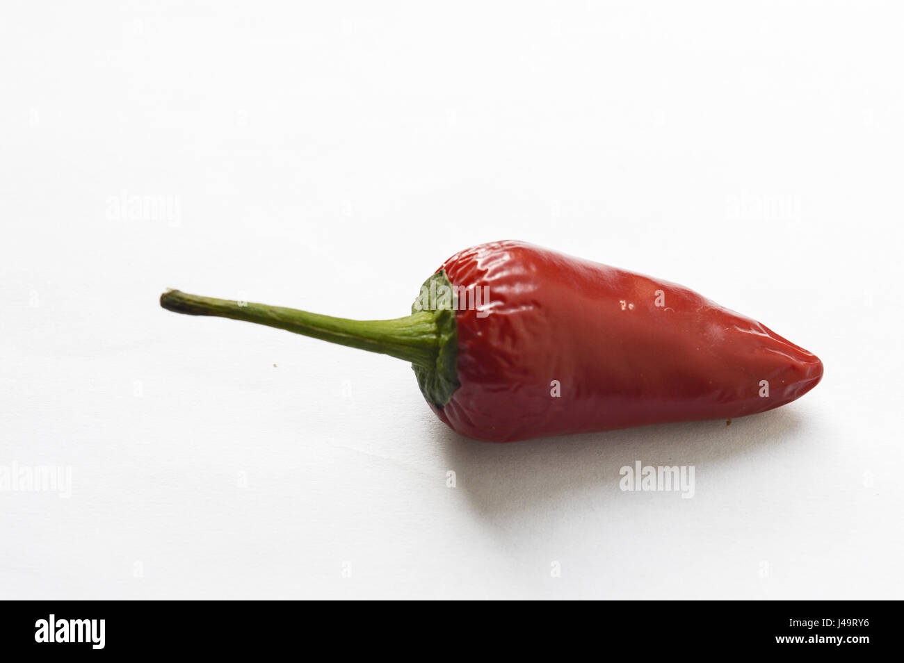 small red chili pepper isolated on white Stock Photo - Alamy