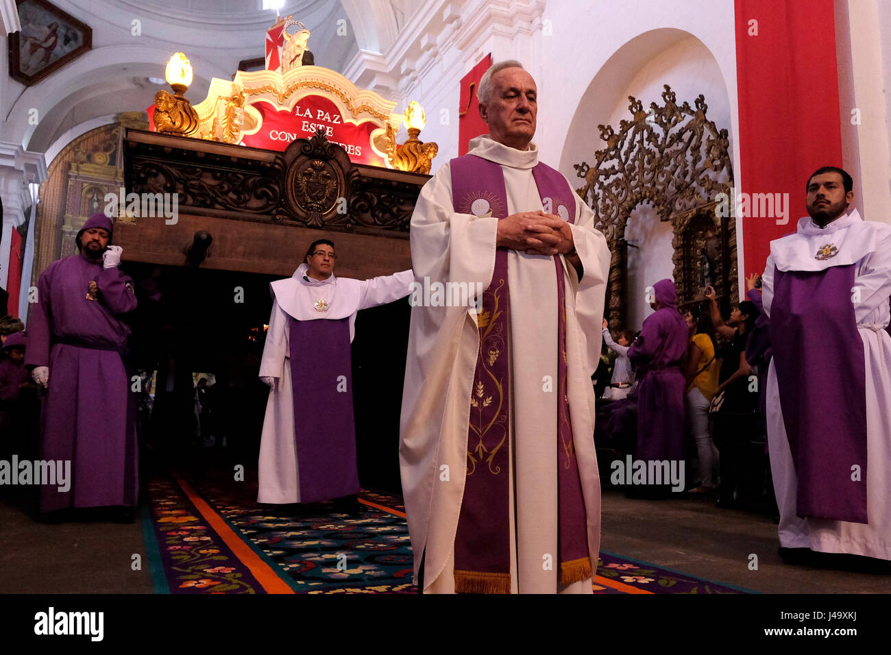 Catholic priests dressed in purple robes carrying the Anda (Float) of ...