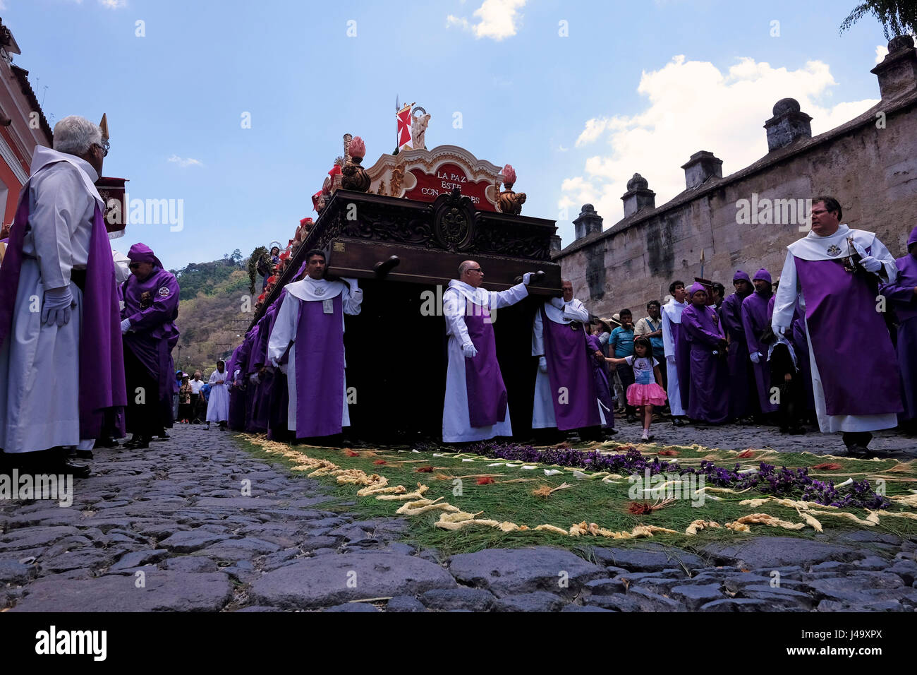 Men dressed in purple robes carrying the Anda (Float) of Jesus carrying ...