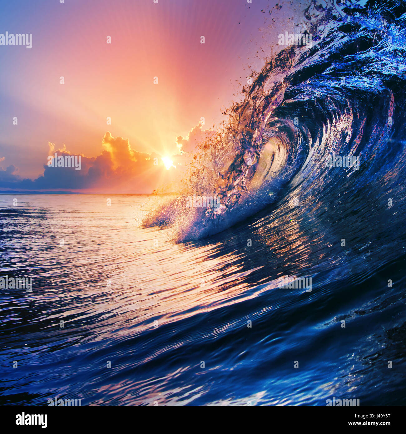 rough colored ocean wave falling down at sunset time Stock Photo - Alamy