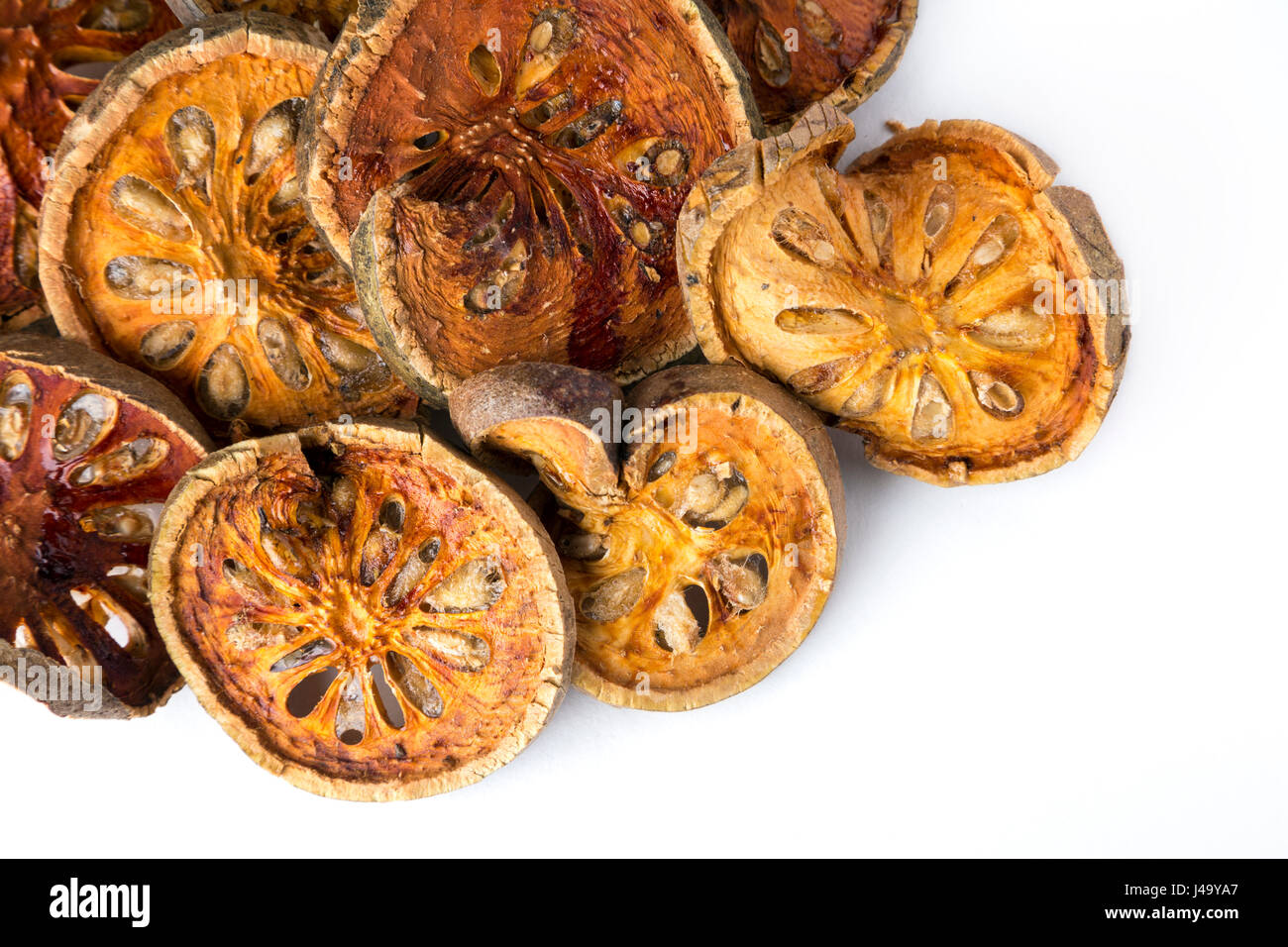 Dried bael fruit on white background Stock Photo - Alamy