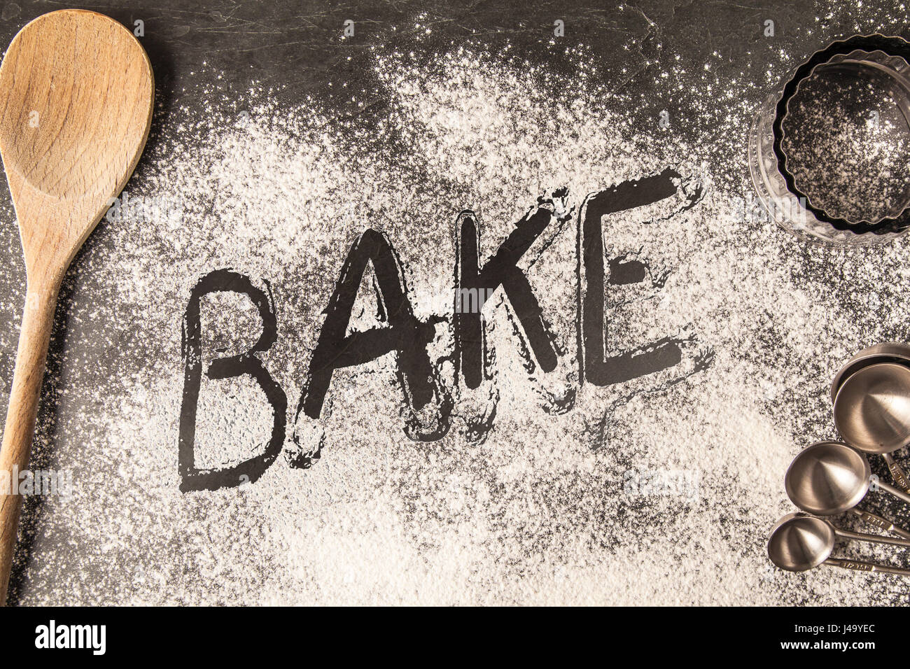 Handwritten word drawn in the flour - Bake Stock Photo - Alamy