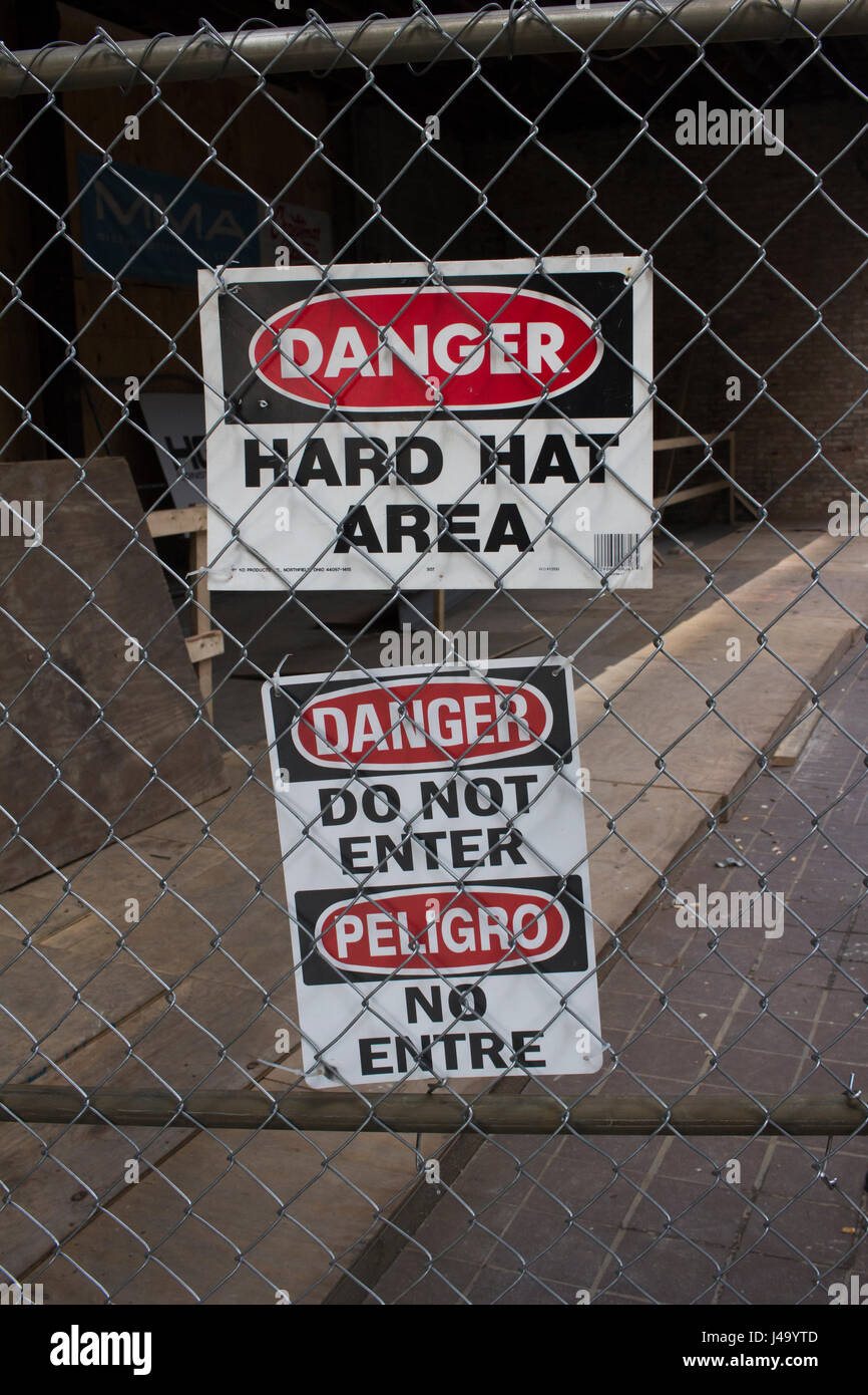 Danger Hard Hat Area sign attached to fence Stock Photo - Alamy