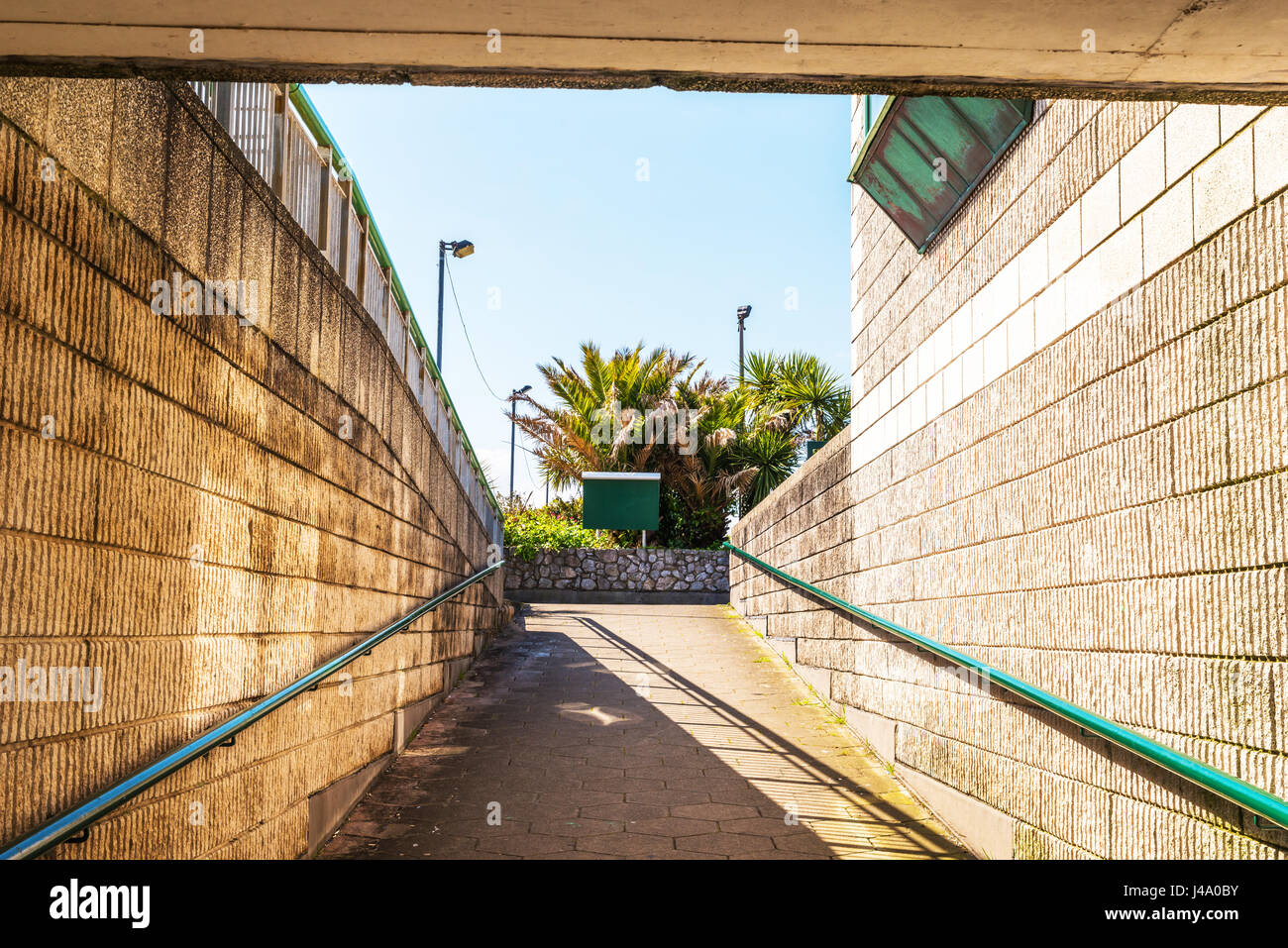 Urban exit with underground passage with balustrade, billboard ...