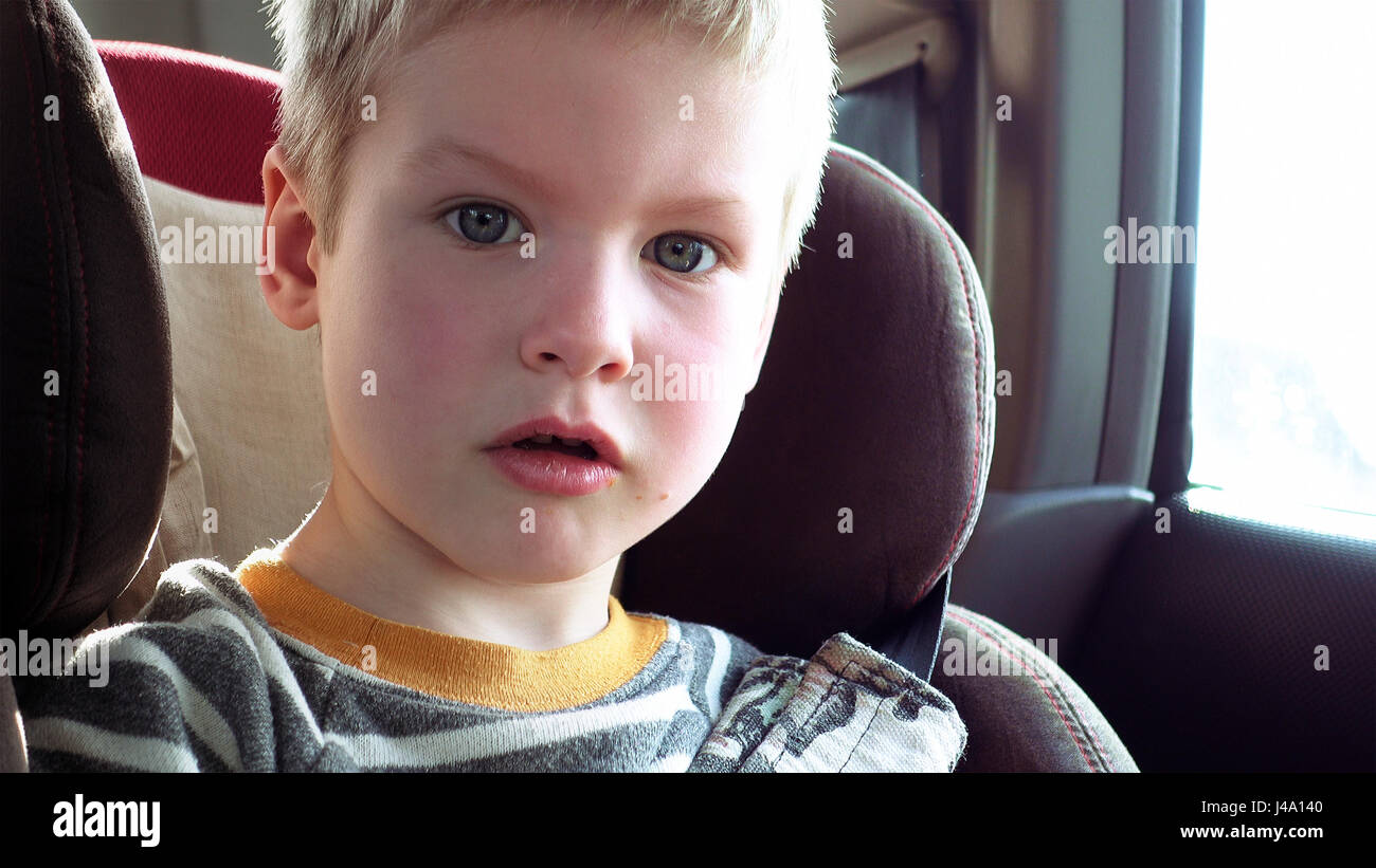 Cute boy in a child car seat Stock Photo - Alamy