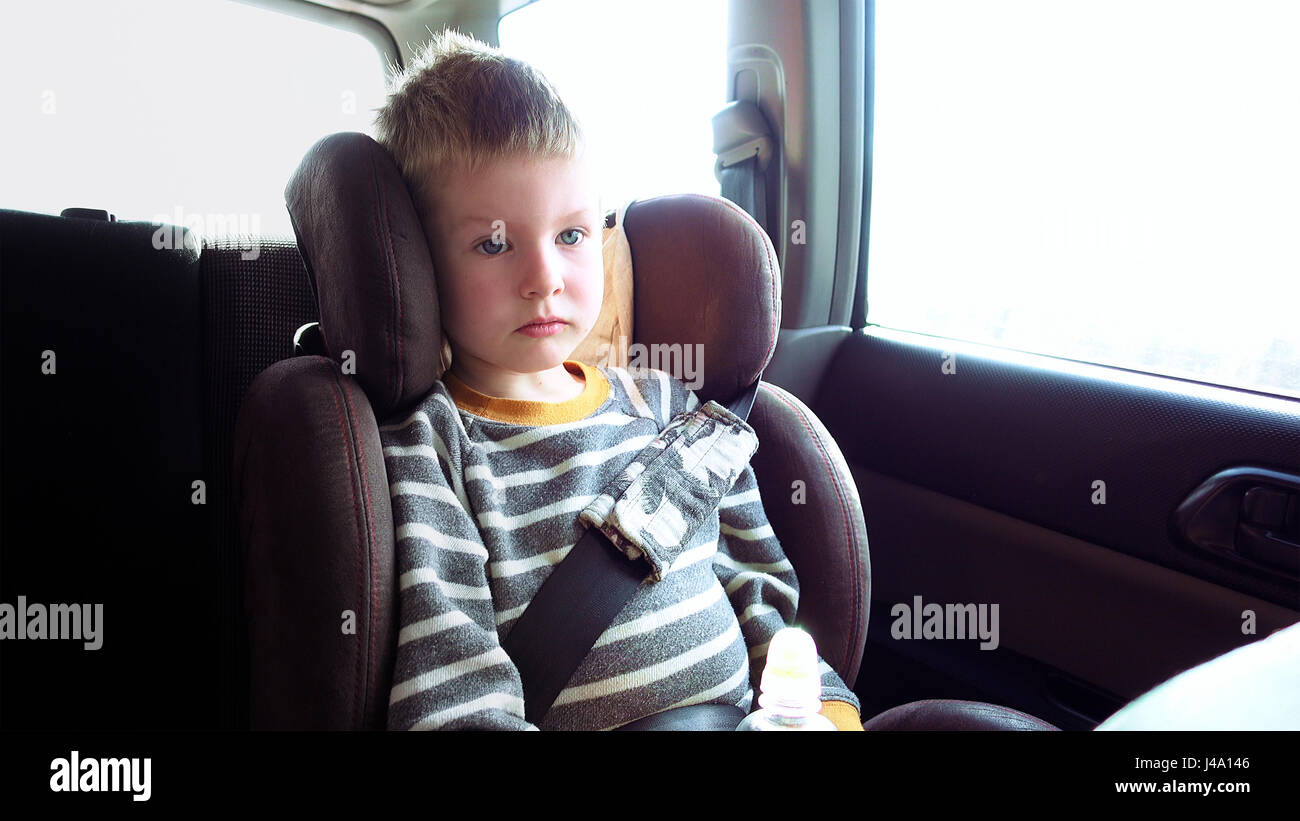 Cute boy in a child car seat Stock Photo - Alamy