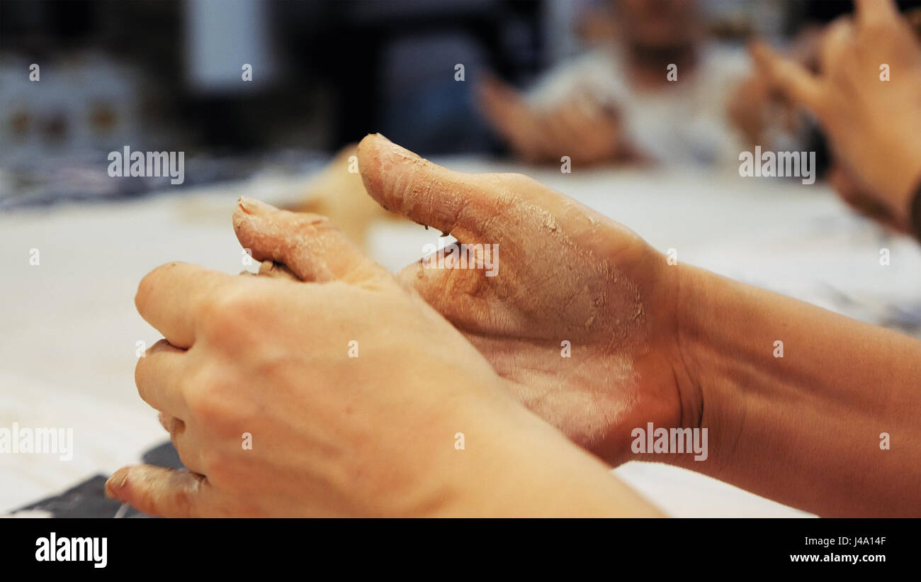 Sculptor is pugging clay for creating pottery Stock Photo - Alamy