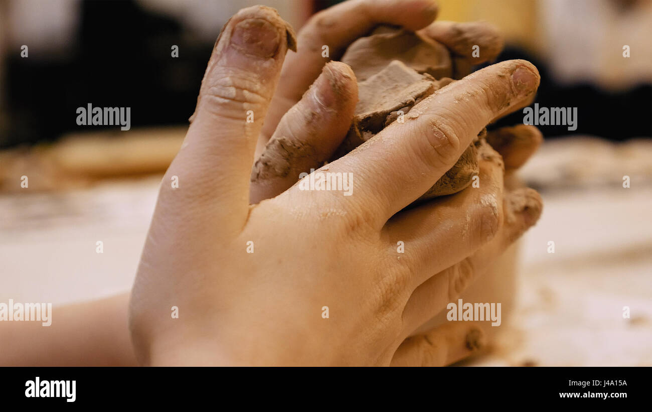 Sculptor is pugging clay for creating pottery Stock Photo - Alamy
