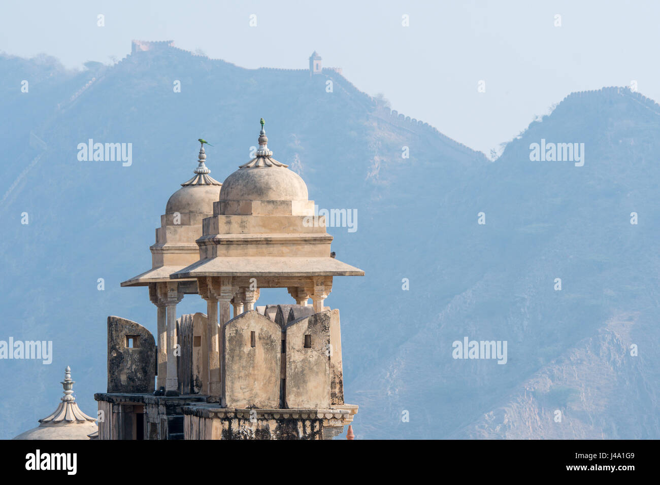 Towers in front of the mountains at the Amer Fort in Jaipur, India ...